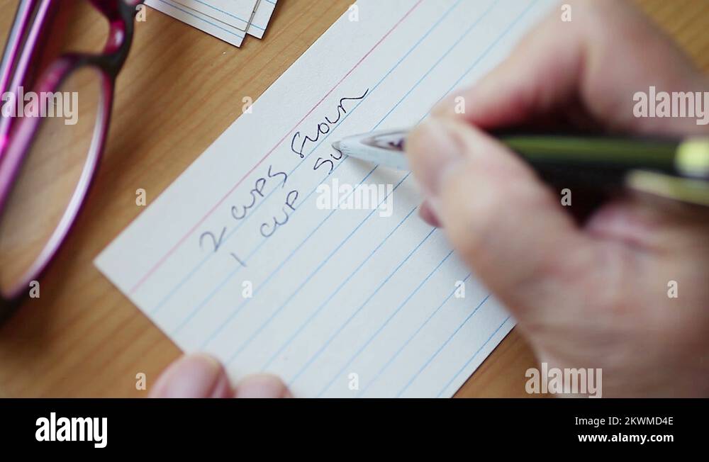 Writing recipe ingredients on index card Stock Video Footage - Alamy