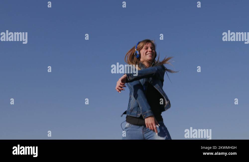 Slow motion of pretty young teenage girl jumpong on trampoline and ...