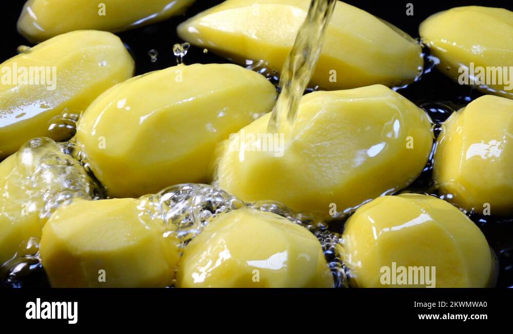 Amazing water flowing and splashing of raw peeled potatoes Stock Video ...