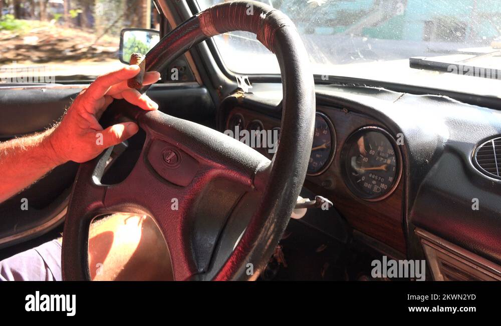 Cuban taxi driver smoking a cigar Stock Video Footage - Alamy