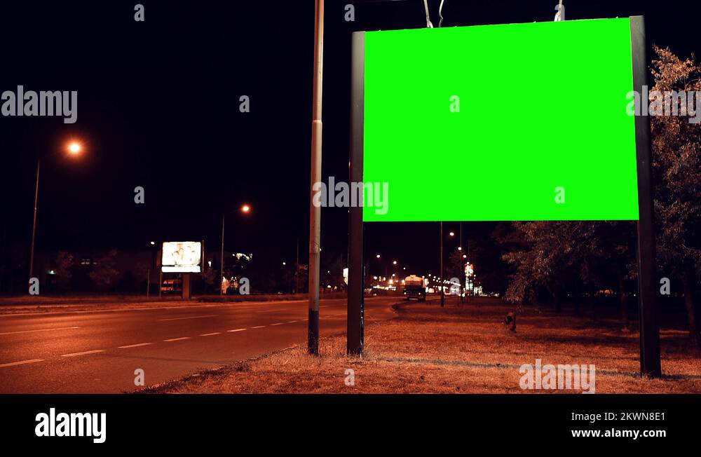 Blank green screen advertising billboard on street at night Stock Video ...