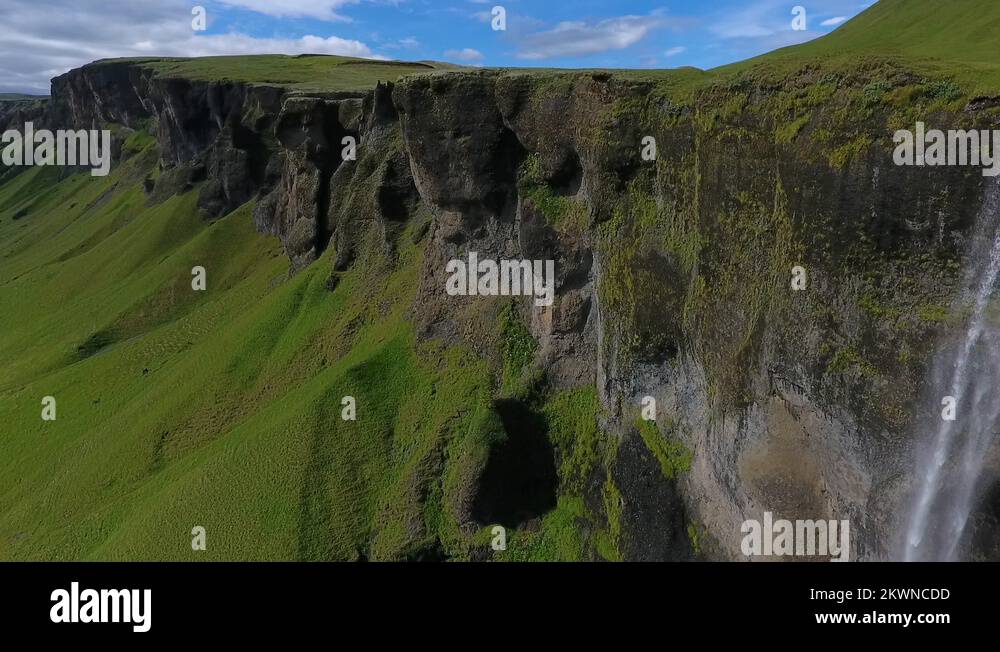 A stream of water flows from a rock cliff. Andreev Stock Video Footage ...