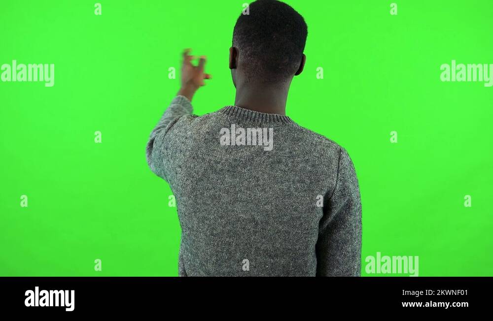 A black man works on an interactive board - green screen studio Stock ...