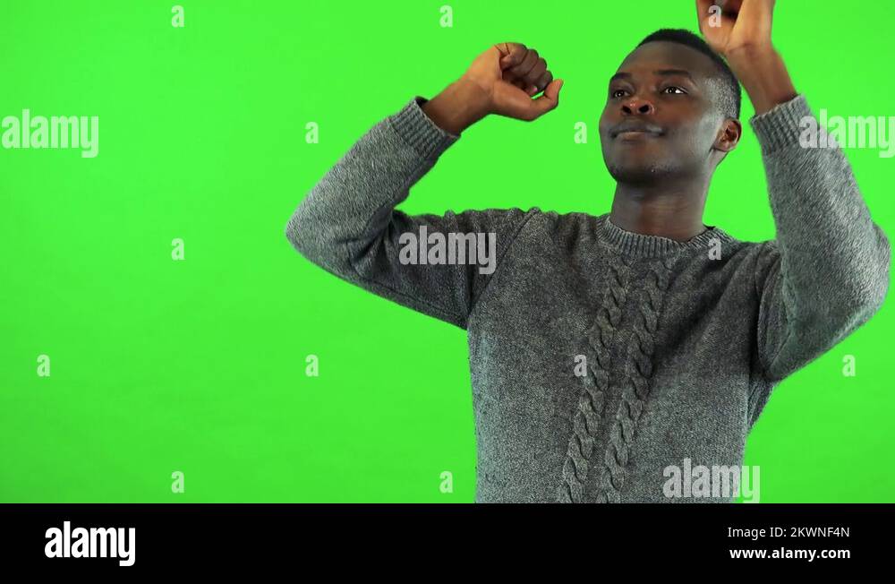 A young black man smiles and dances - green screen studio Stock Video ...