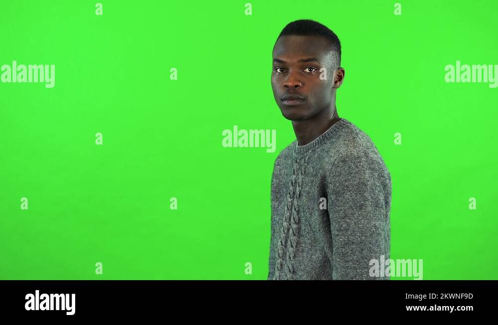 A young black man poses for the camera - green screen studio Stock ...