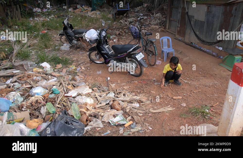 Little Girl Playing With Garbage on Street In Asian Slums of Cambodia ...