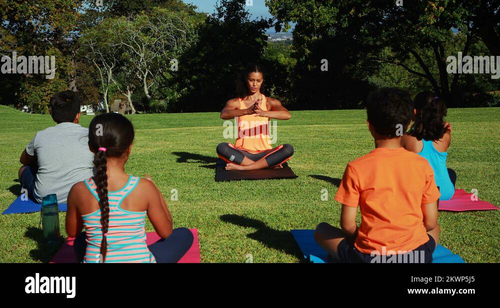 Yoga instructor instructing children in performing exercise Stock Video ...