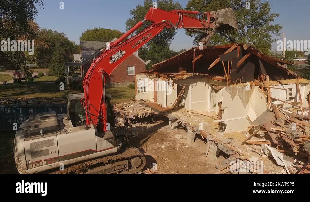 Excavator Chomping Roof of Demolished House Stock Video Footage - Alamy