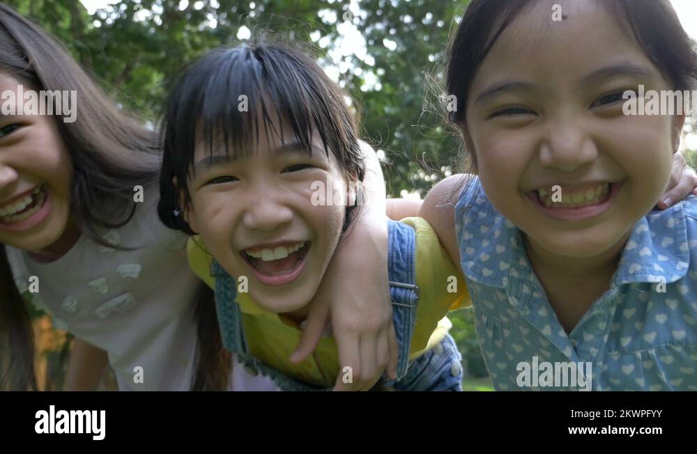 4K : Group of little happy Asian girls playing together in the park ...