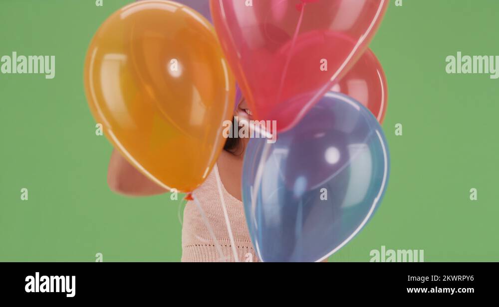 Millennial Latina girl popping her balloons on green screen Stock Video ...