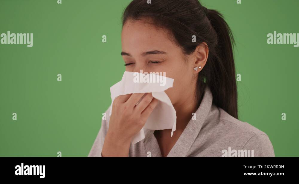 Young millennial girl blowing your nose on green screen Stock Video ...