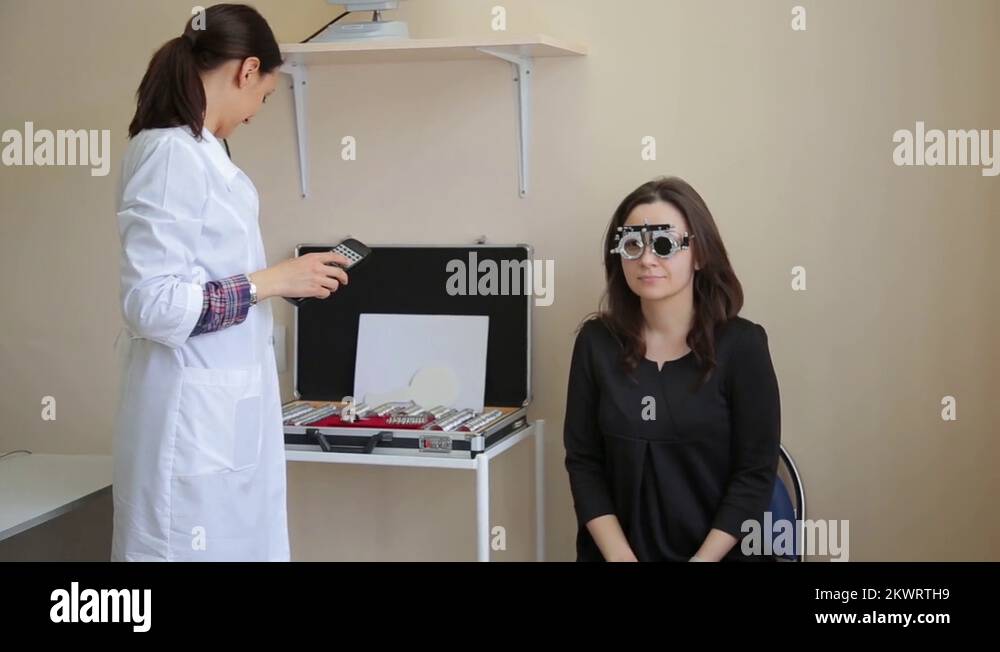Woman doctor examines a woman's vision to a patient using new medical ...