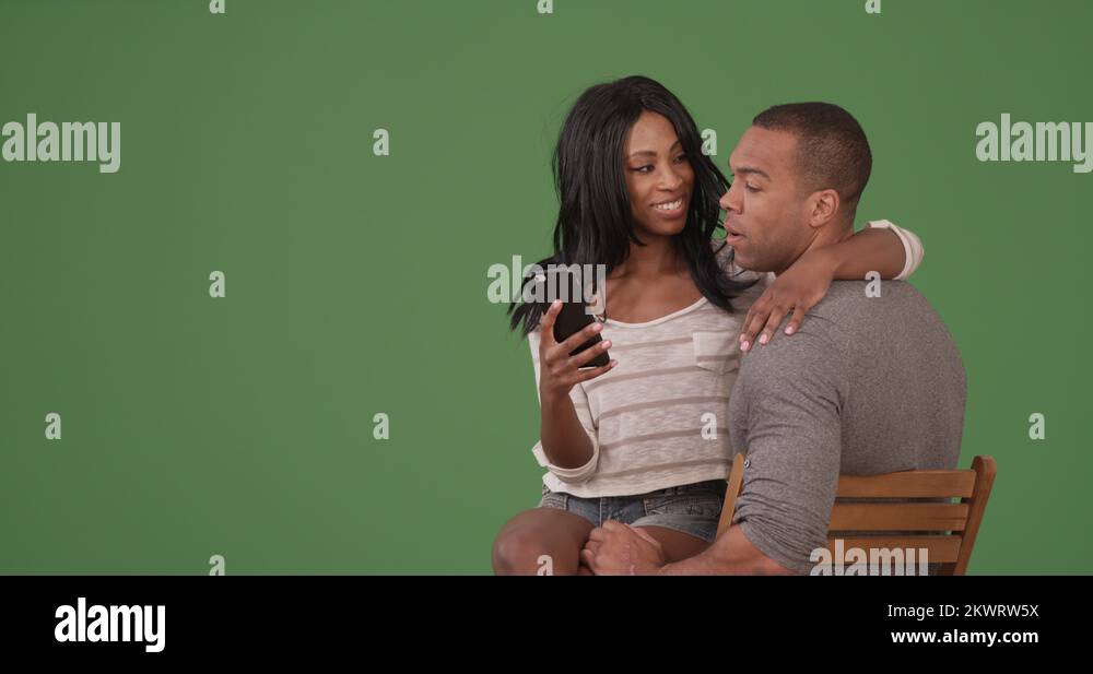 Black couple cuddling on a patio chair on green screen Stock Video ...