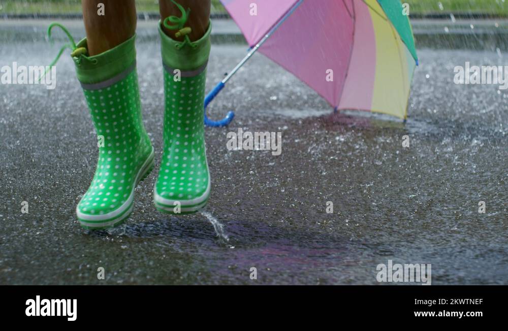Girl jumping into puddle Stock Videos & Footage - HD and 4K Video Clips ...