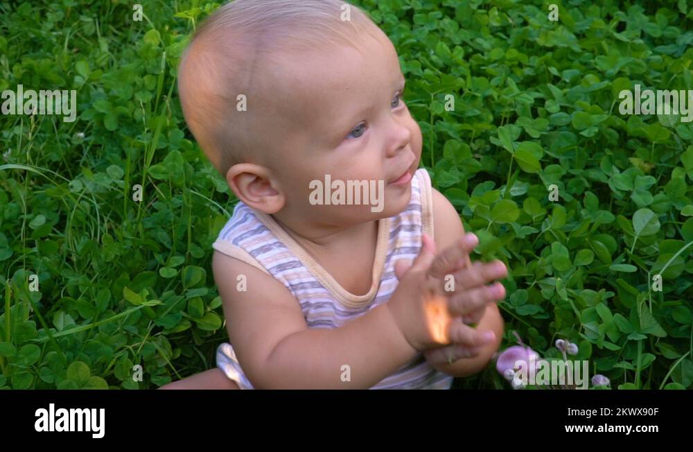 little boy sitting and clapping Stock Video Footage - Alamy