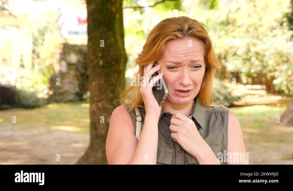 the woman feels sad and crying, talking to someone on the mobile phone ...