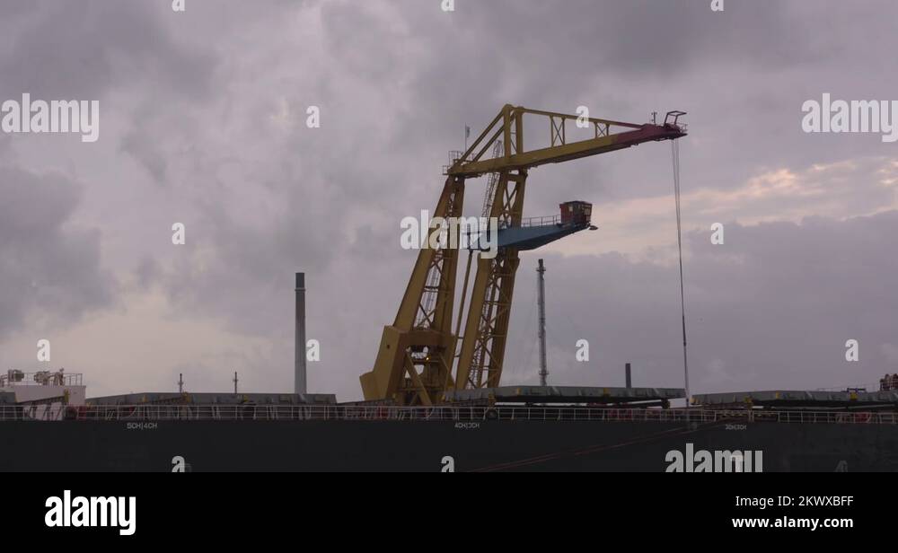 Unloading a dry bulk carrier, ship-to-ship, using a floating crane ...