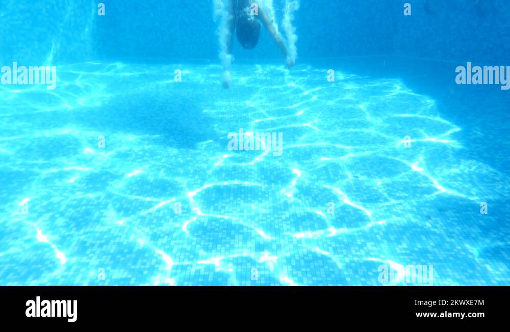 children swim under water. girl with long hair dives into the water. 4k ...
