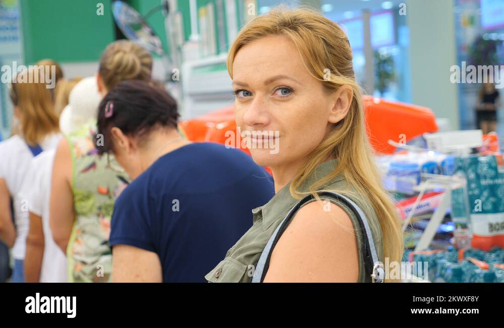 The queue of people standing at the checkout in the supermarket. 4k ...