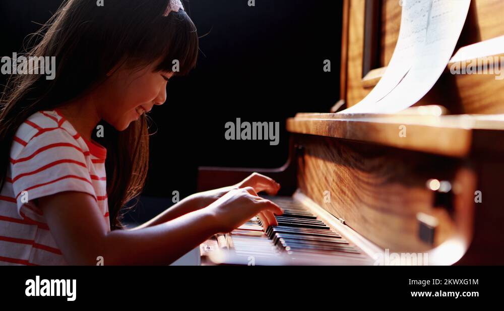 Schoolgirl learning piano in music class 4k Stock Video Footage - Alamy