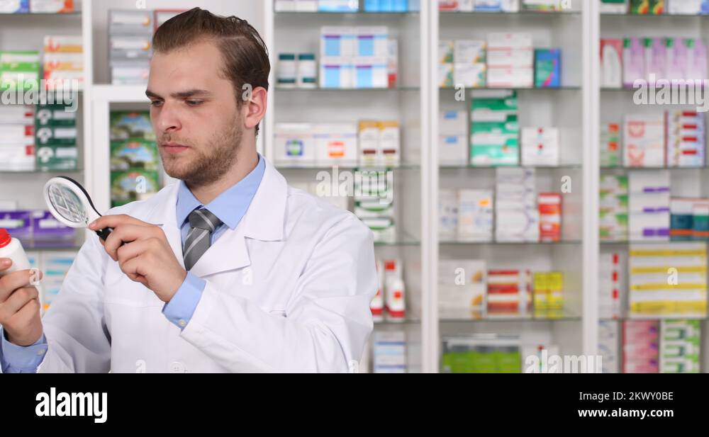 Druggist Man Checking Expiration Date of Drug Using Magnifying Glass in ...