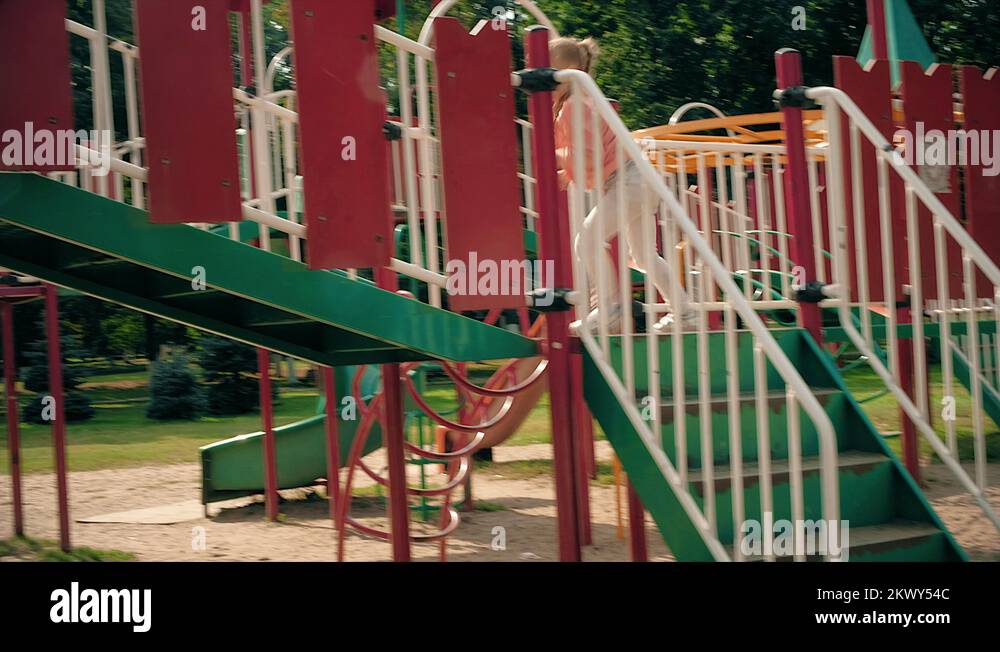 Child Sliding on a Slide in Park, Little Girl Playing at Playground ...