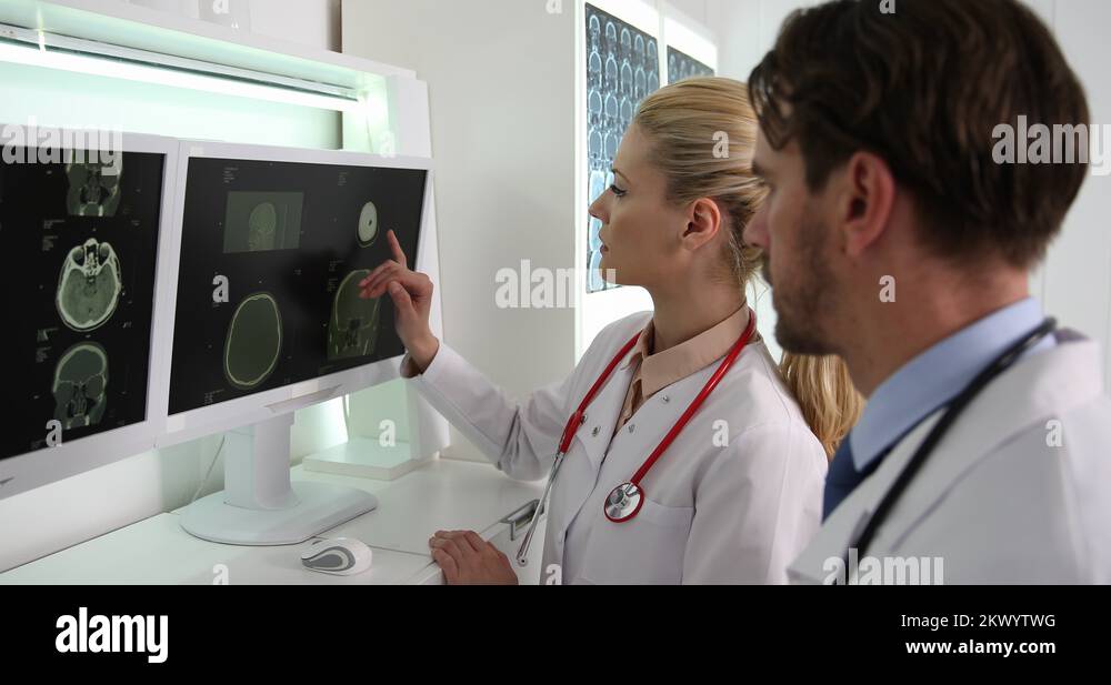 Doctor Man and Woman Look to Brain Mri Teamwork Collaboration in ...