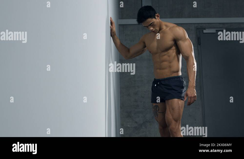 Fitness Model Leg Stretches By A Wall And Smiles Stock Video Footage Alamy