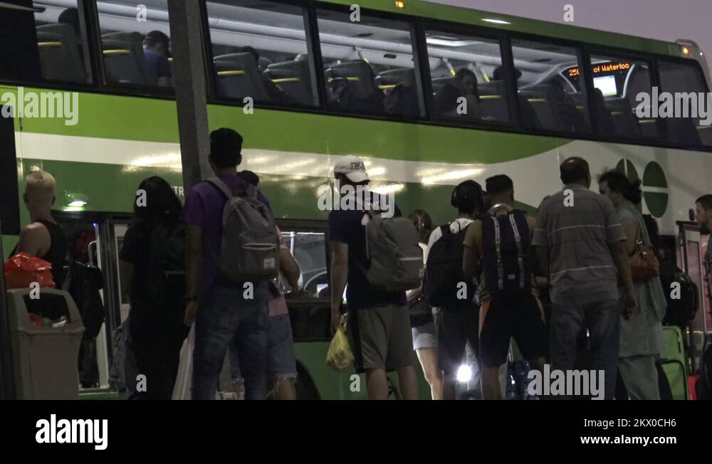 Diverse students from different universities lining up at GO bus ...