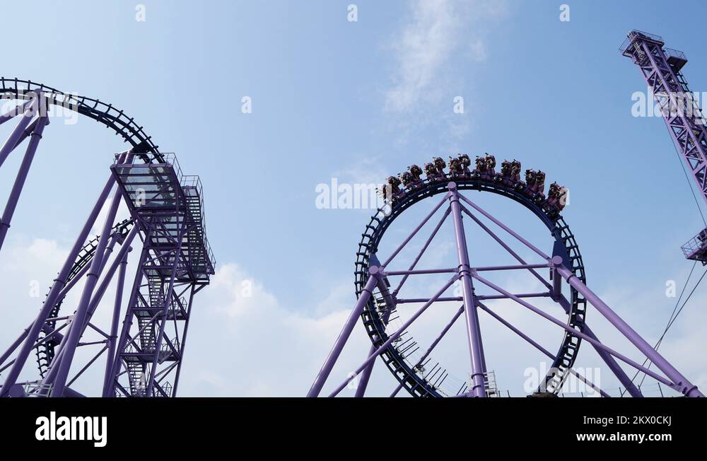 roller coaster, a trolley with people riding on the loops of a roller ...