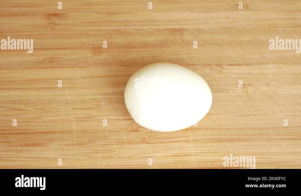 a man cleans and cuts a chicken egg. Body Builder Cuts Egg Whites and ...
