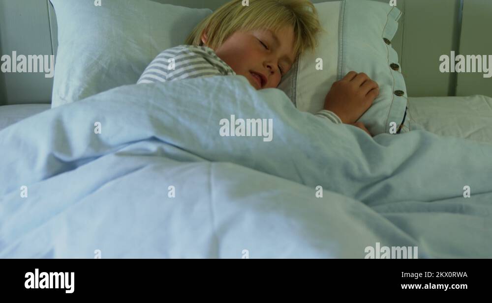 Boy sleeping on bed in the bedroom 4k Stock Video Footage - Alamy