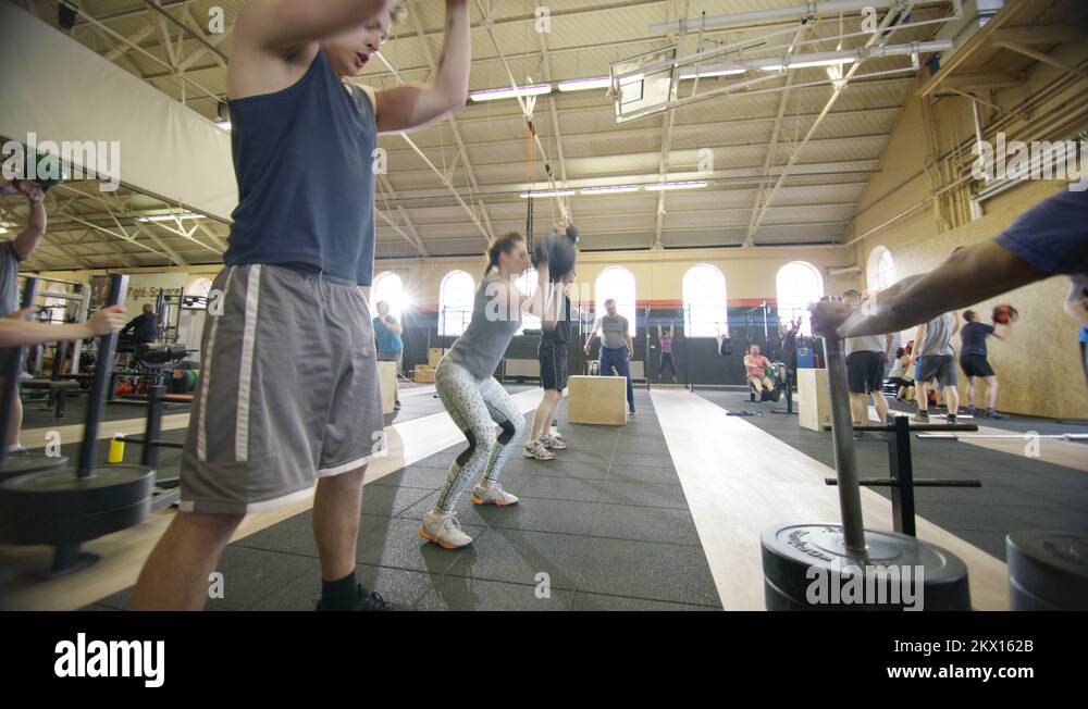People exercising in gym studio using strength equipment Stock Video ...