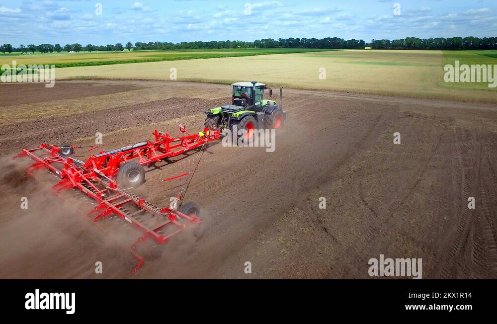 Ploughing field. Agricultural tractor plowing farming field. Farming ...