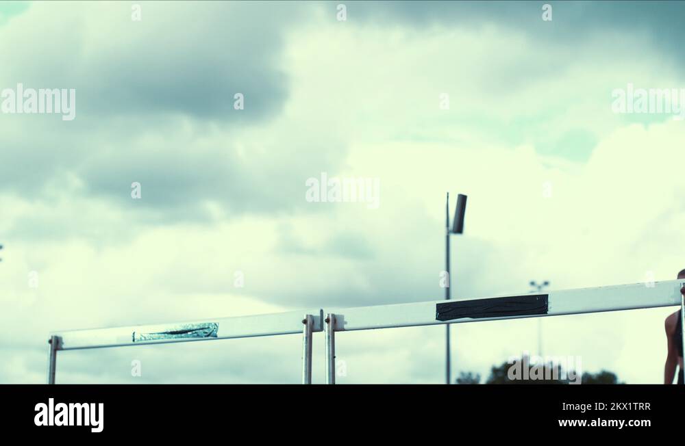 Female hurdle athletes training on running track, shot on Phantom Flex ...