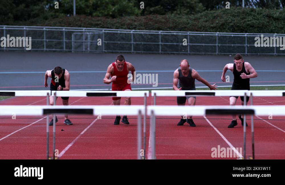 Male hurdle athletes training on running track, shot on Phantom Flex at ...