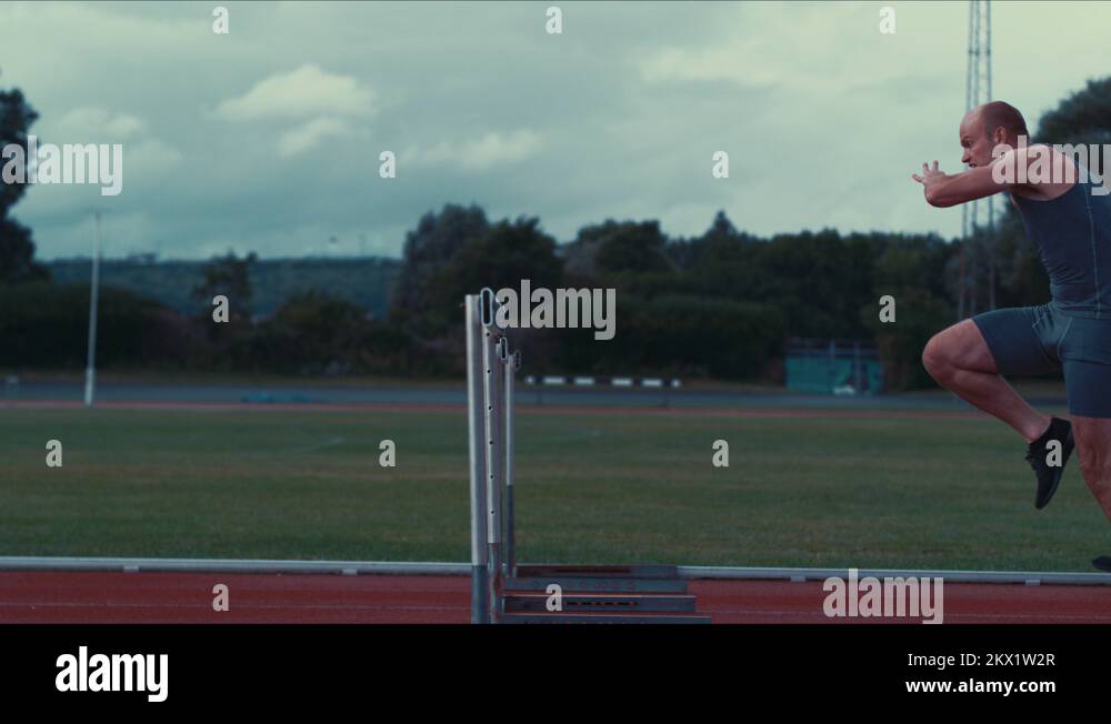 Male hurdle athletes training on running track, shot on Phantom Flex at ...