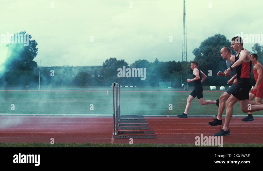 Male hurdle athletes training on running track, shot on Phantom Flex at ...