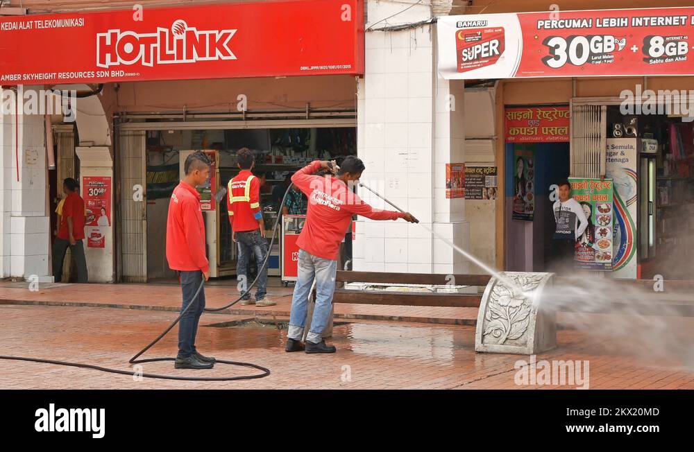 Cleaners using high pressure water to washing the public bench Stock ...