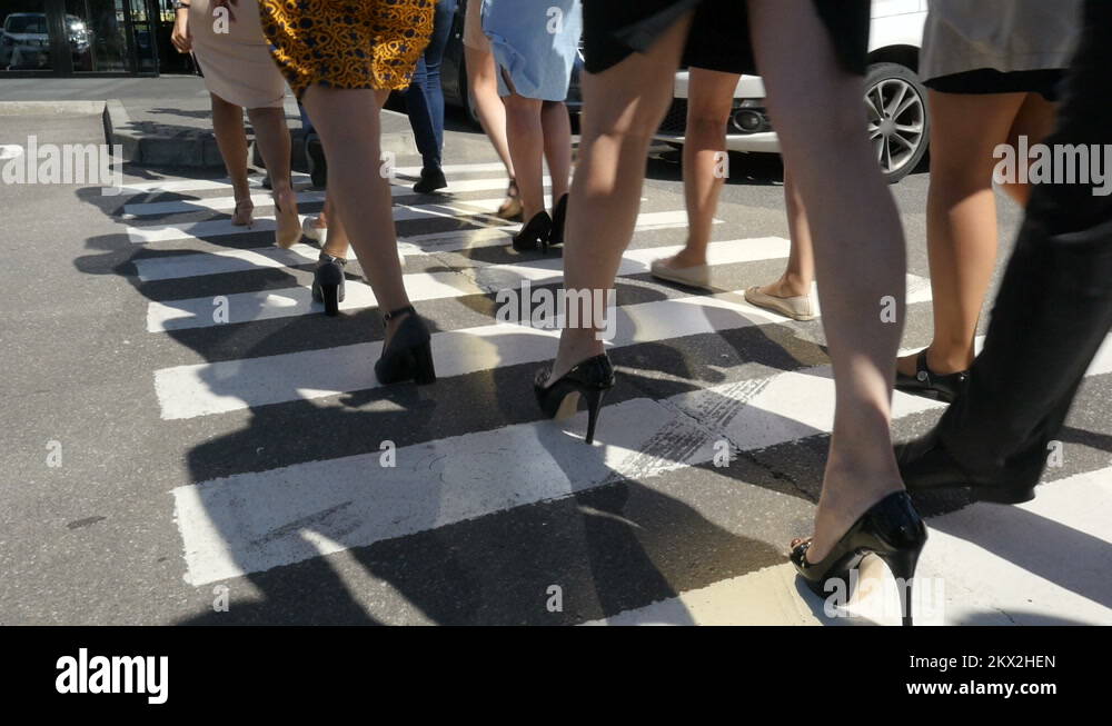 Men's and women's feet go on a pedestrian crossing Stock Video Footage ...
