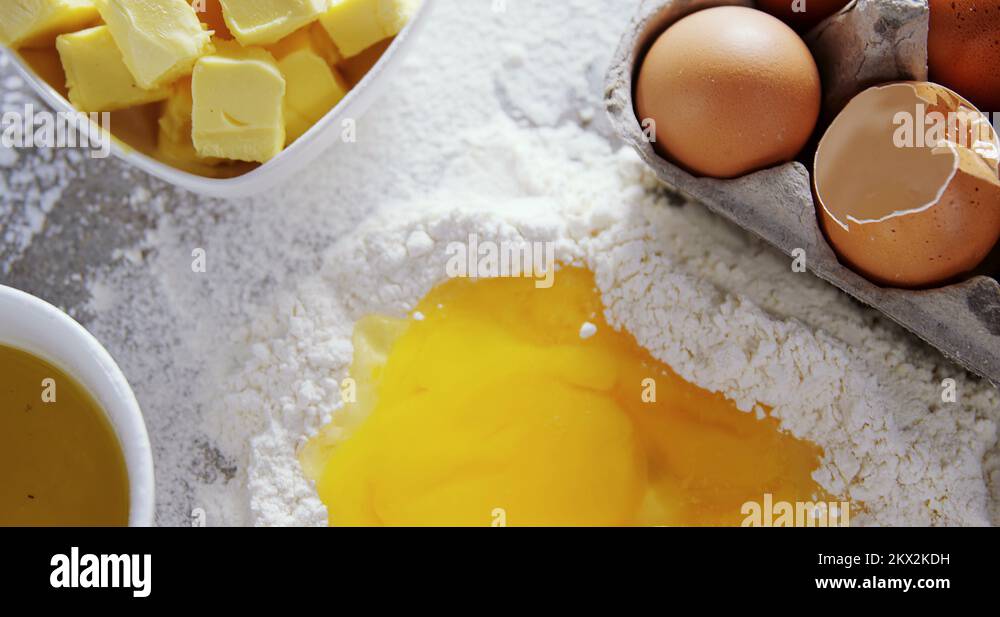 Egg yolk mixed with flour 4k Stock Video Footage - Alamy