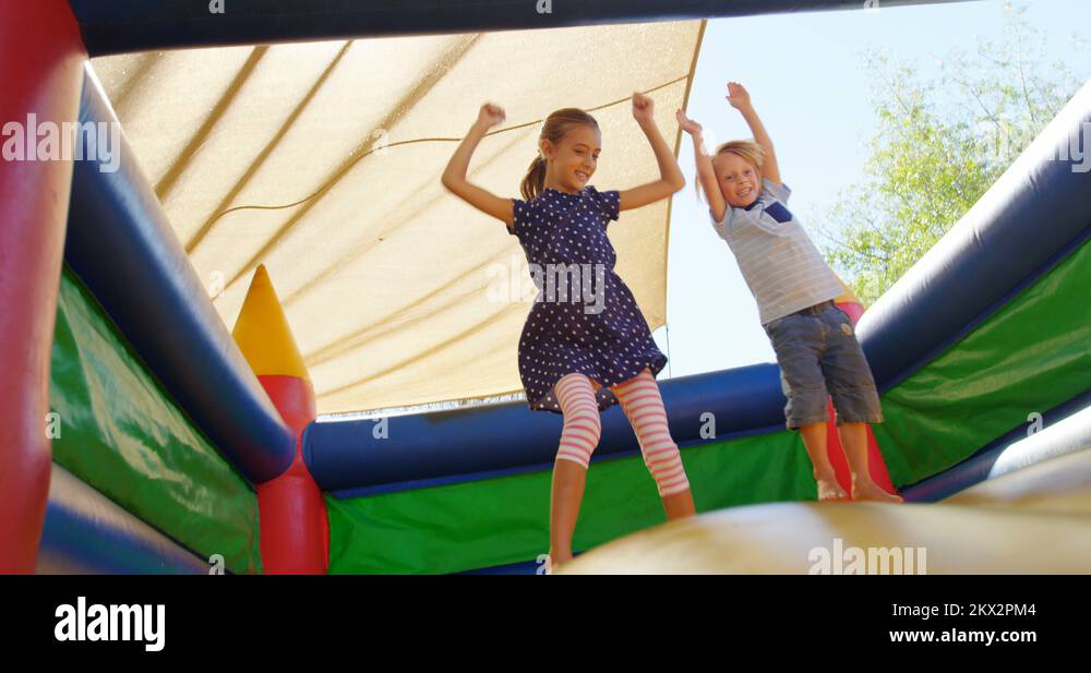 Kids playing on the bouncing castle 4k Stock Video Footage - Alamy