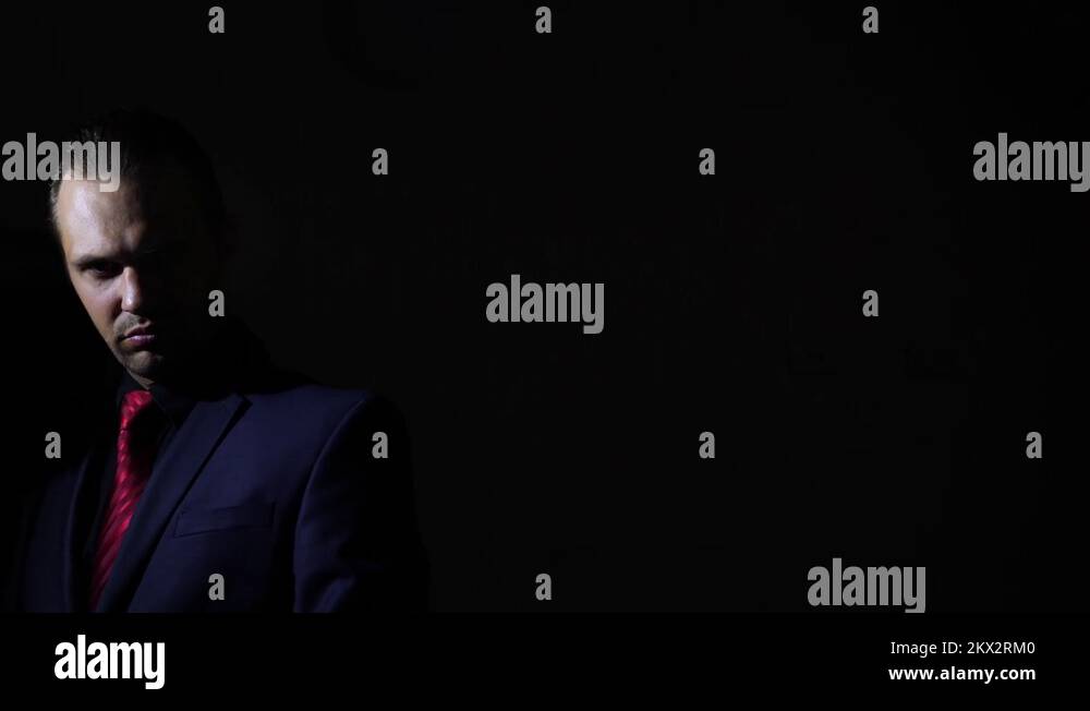 Man pulling out his gun in the darkness and aiming at the camera. 4k ...