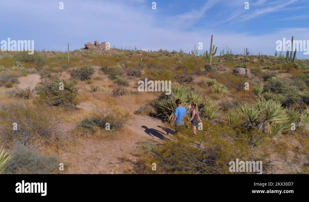 Hikers on a Trail Through the Desert by Aerial Drone Stock Video ...