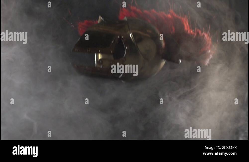 Spartan helmet falling in slow motion through thick smoke Stock Video ...