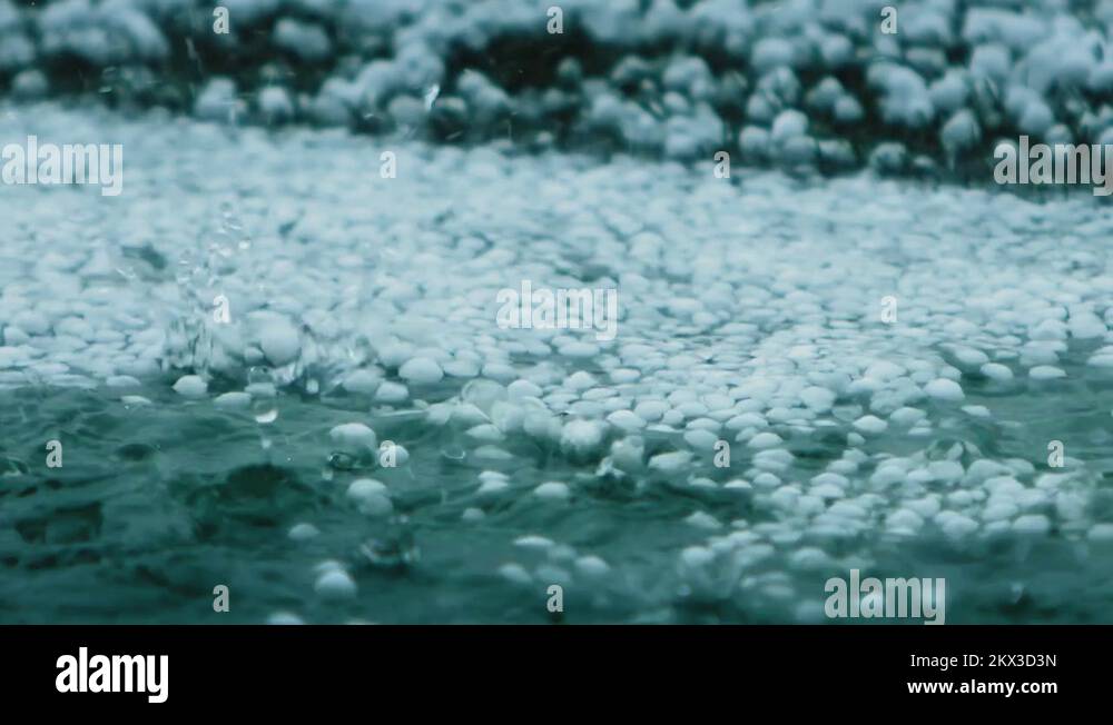 Spectacular summer hailstorm. Hailstones falling in a rain puddle Stock ...