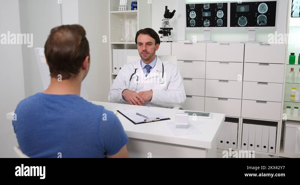 Medical Doctor Handwriting on Clipboard Asking Questions to Patient Man ...