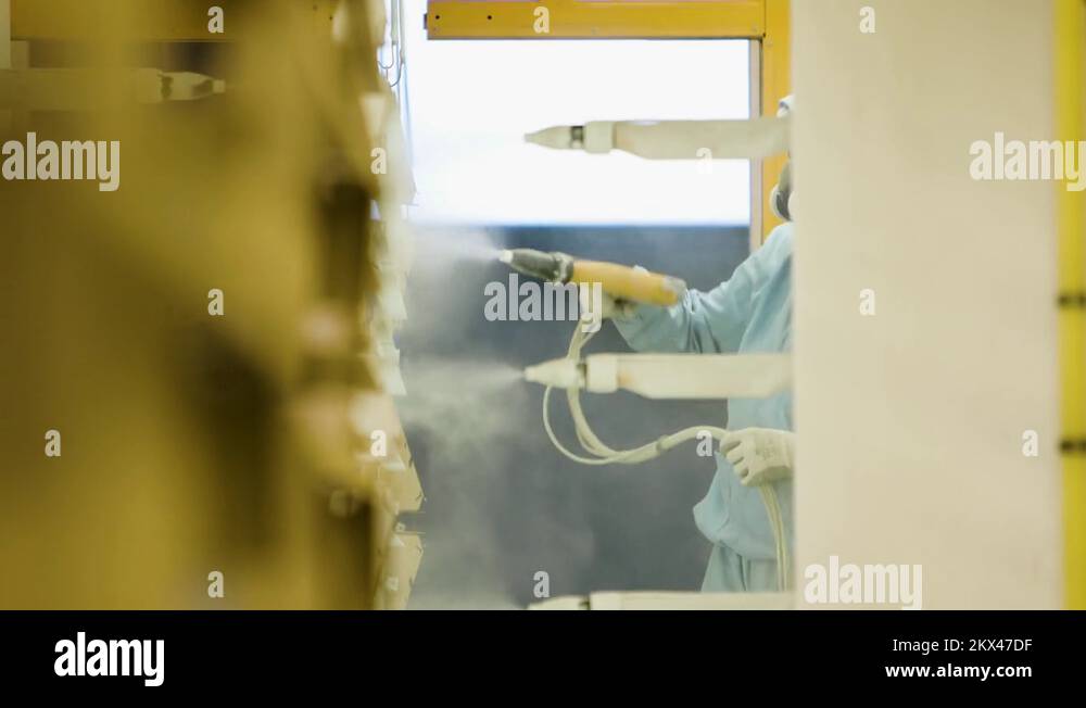 Metal surface finish. Industrial powder coating by unrecognizable ...