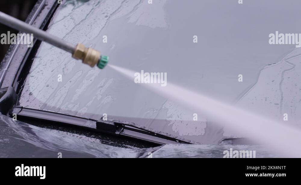 Cleaning car window with pressure washer close up - extreme close up ...