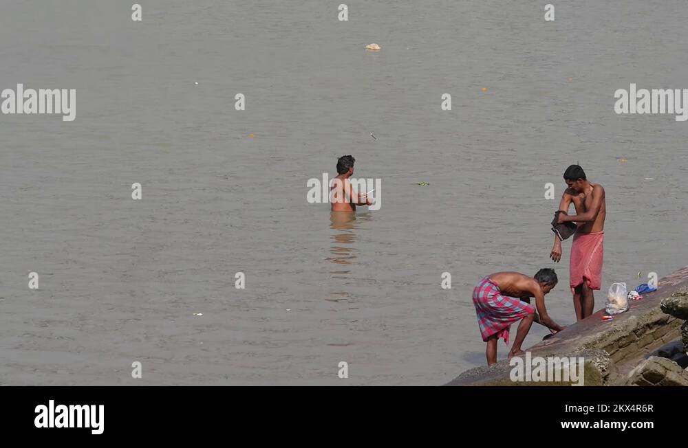 People washing clothes, praying and doing their ablutions on the ...